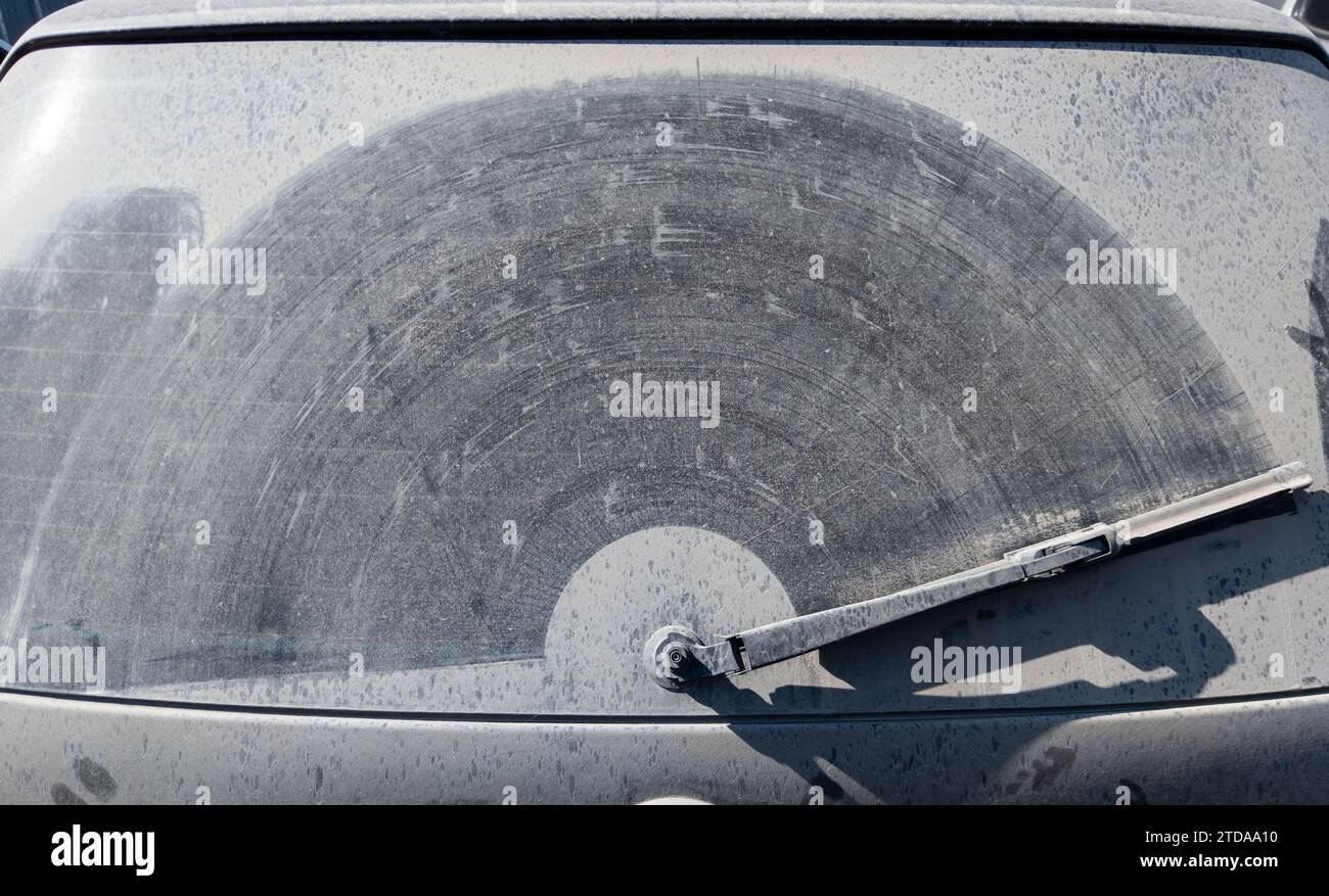 dusty rear window of the car with wiper trace on layer of dirt Stock ...