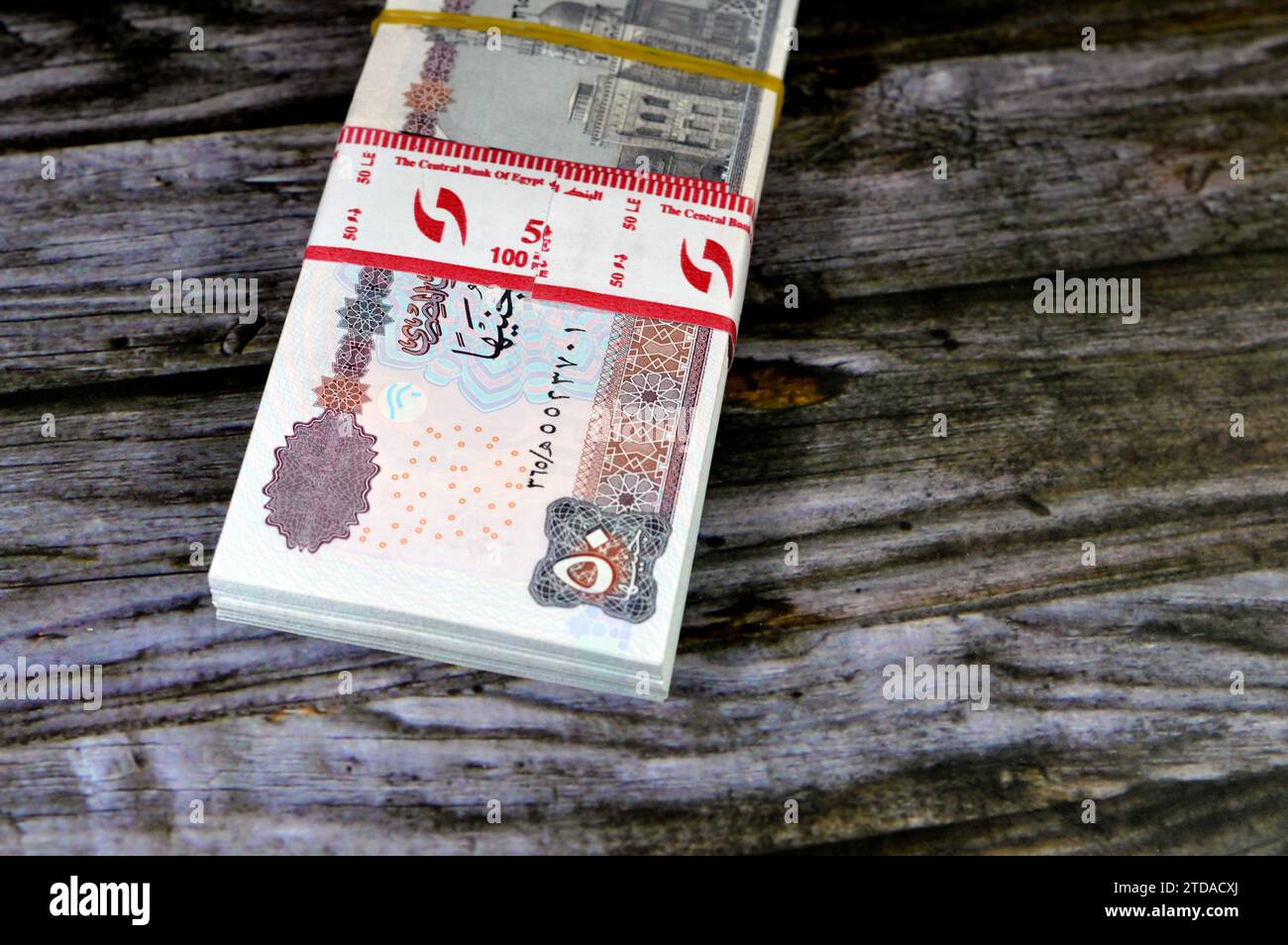 Egypt money stack of pounds isolated on wood background, pile of 50 EGP ...