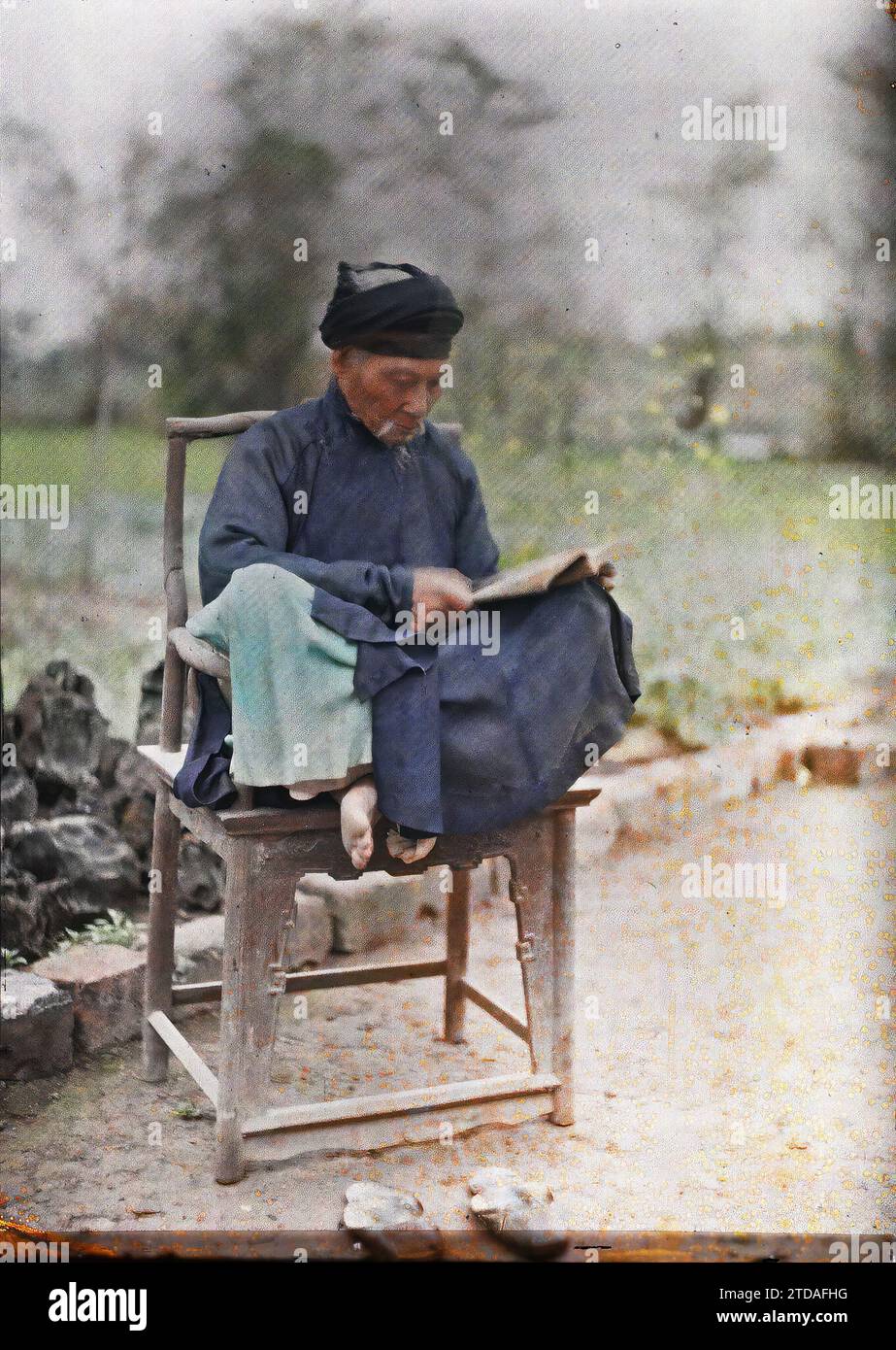 Tonkin, Indochina A scholar reading, sitting cross-legged in a wooden ...