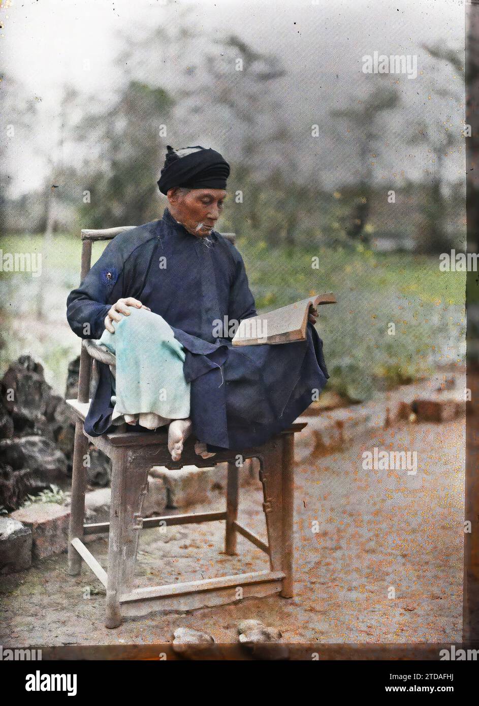 Tonkin, Indochina A scholar reading, sitting cross-legged in a wooden ...