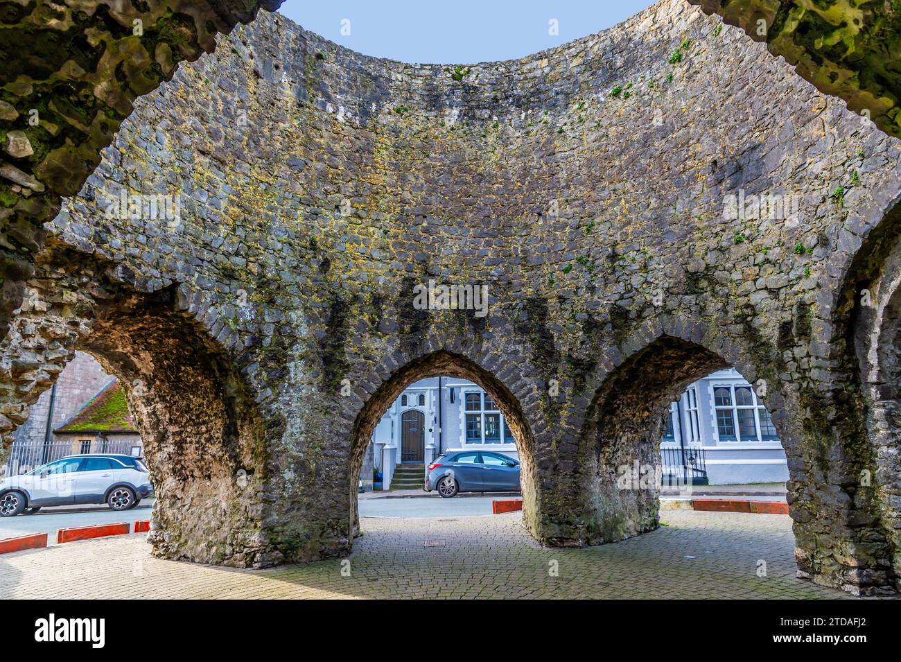 A view through the five arches entrance in the town walls in Tenby ...