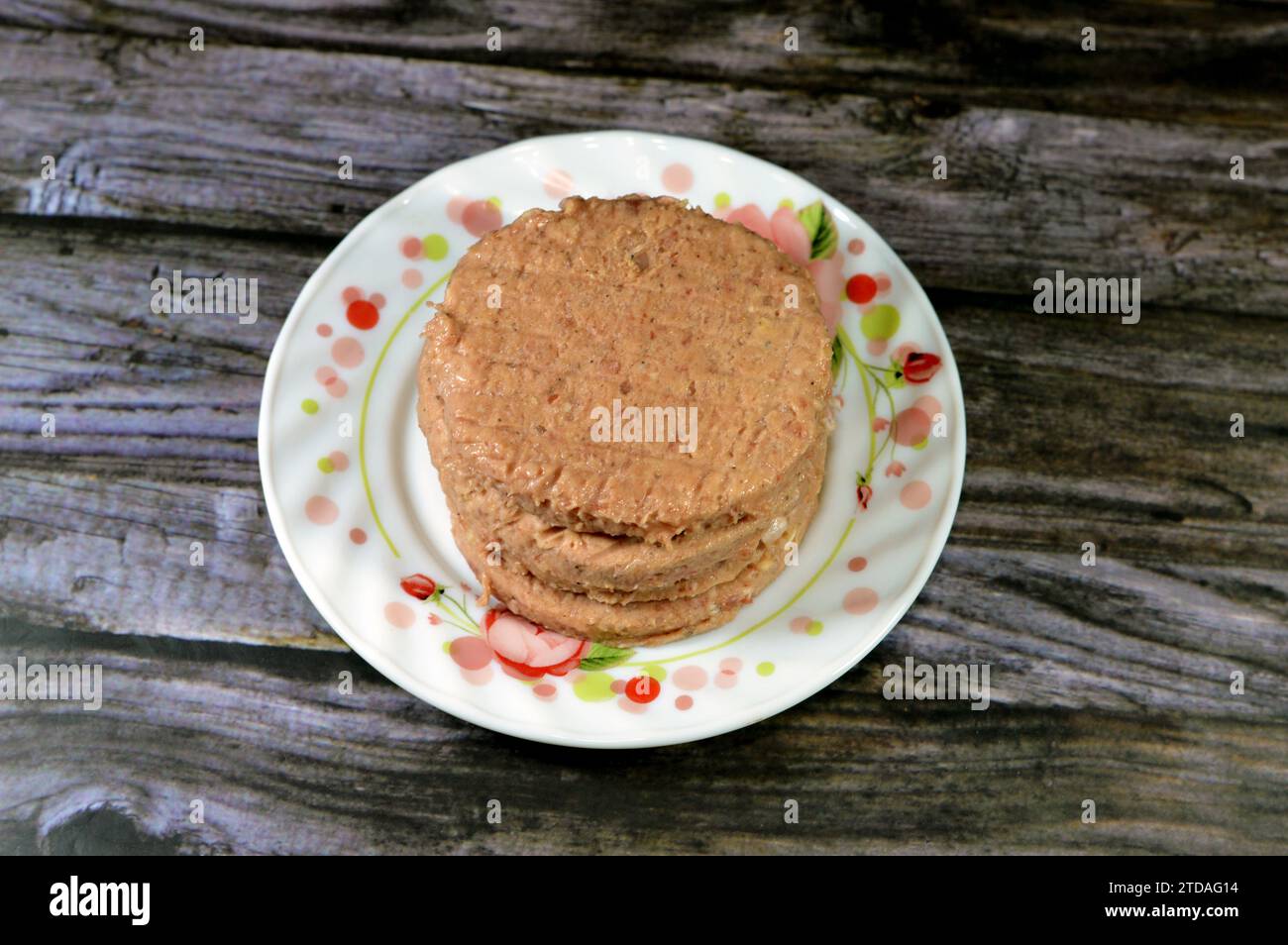 Raw uncooked beef burger ready to be cooked and fried in shallow oil ...