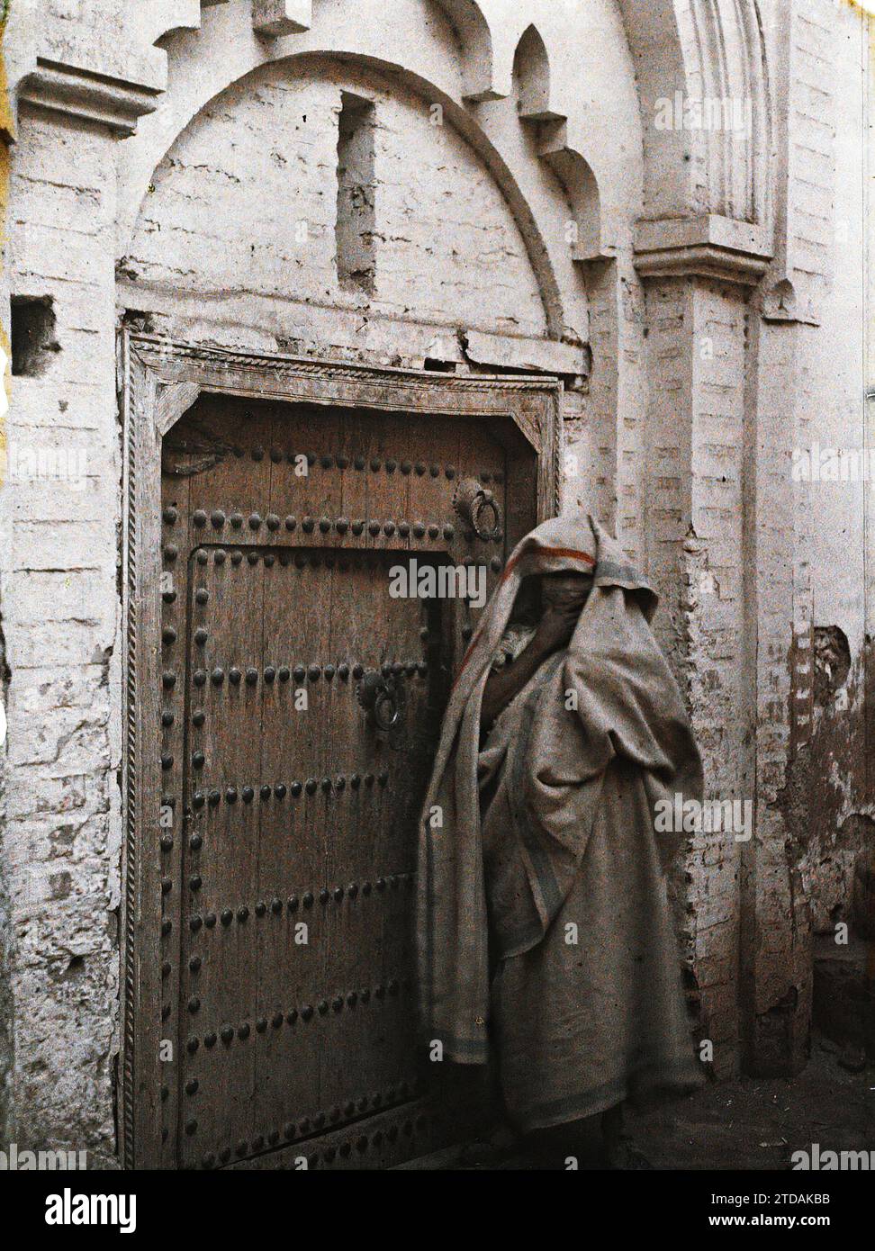 Marrakech, Morocco Woman in front of a studded door, Human beings ...