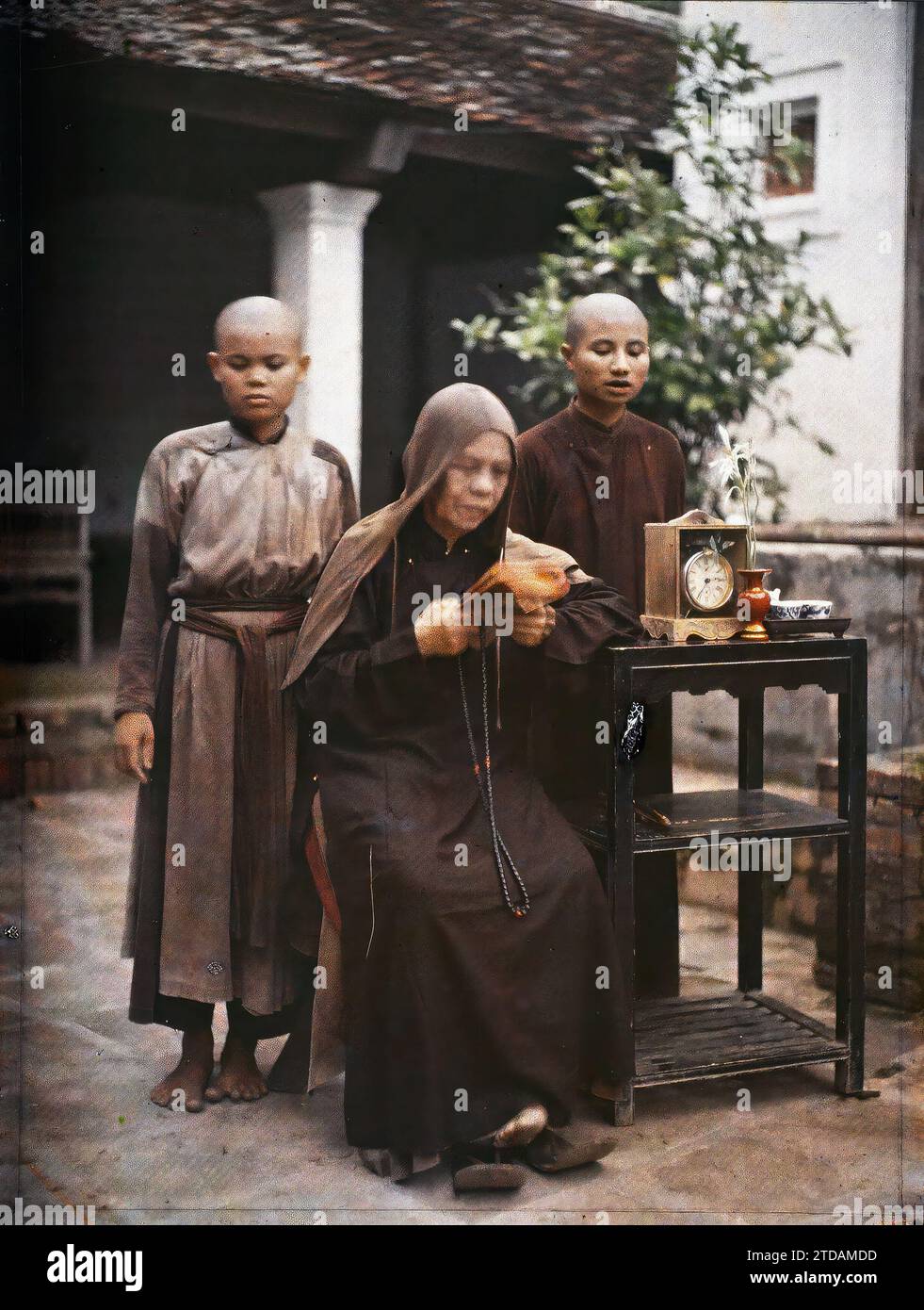 Hà-nôi, Hainoi Vietnam, Tonkin, Indochina A nun reading in front of two ...