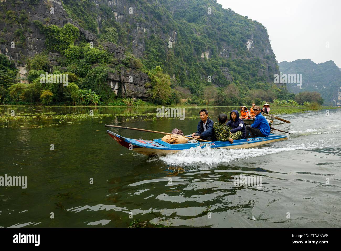 Tourist on a boat tour at Tam Coc in vietnam Stock Photo - Alamy