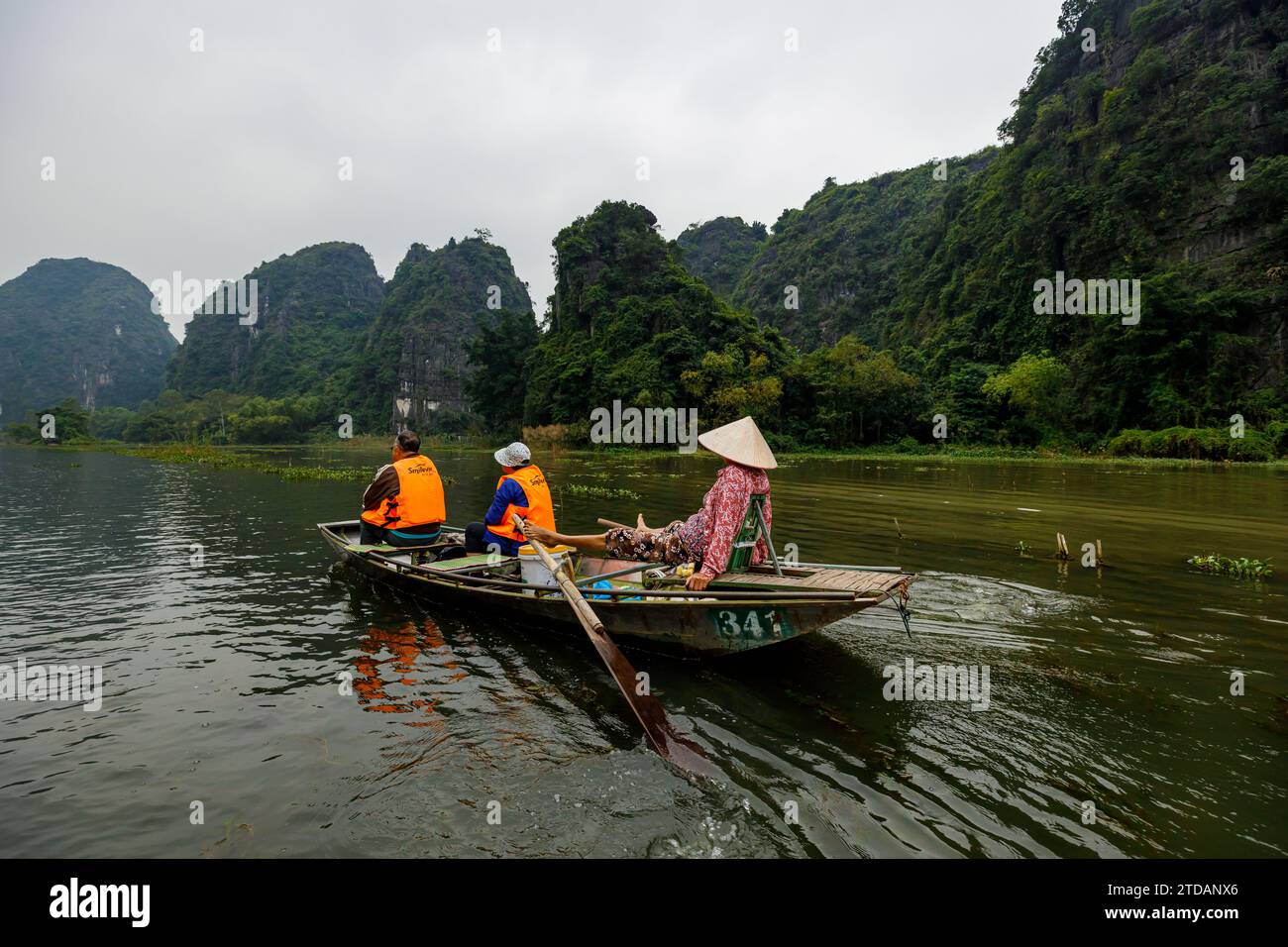 Tourist on a boat tour at Tam Coc in vietnam Stock Photo - Alamy