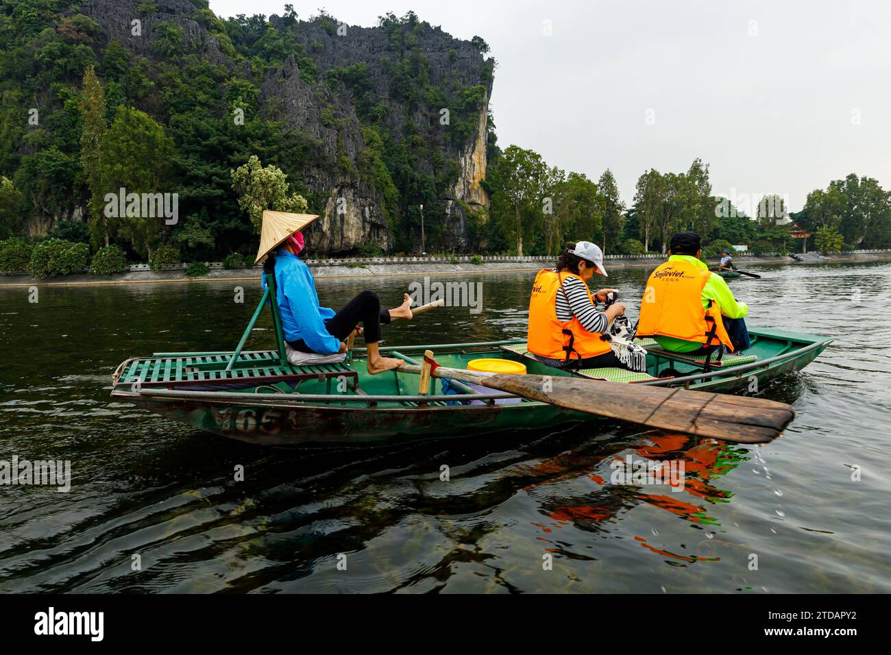 Tourist on a boat tour at Tam Coc in vietnam Stock Photo - Alamy
