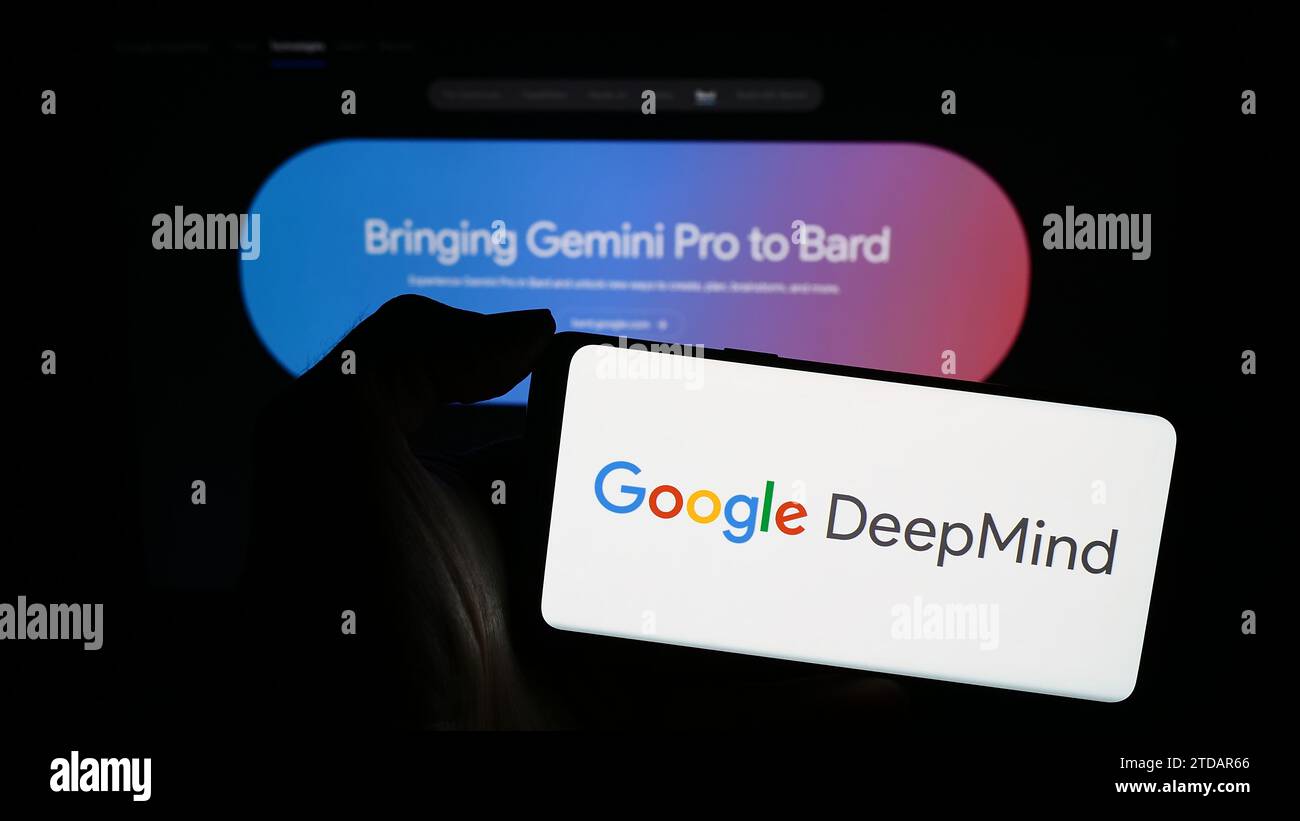 Person holding mobile phone with logo of artificial intelligence ...