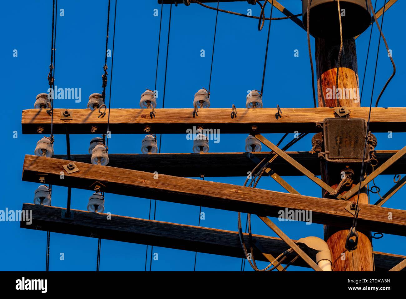 Frosted isolators on an old wood telephone pole Stock Photo - Alamy