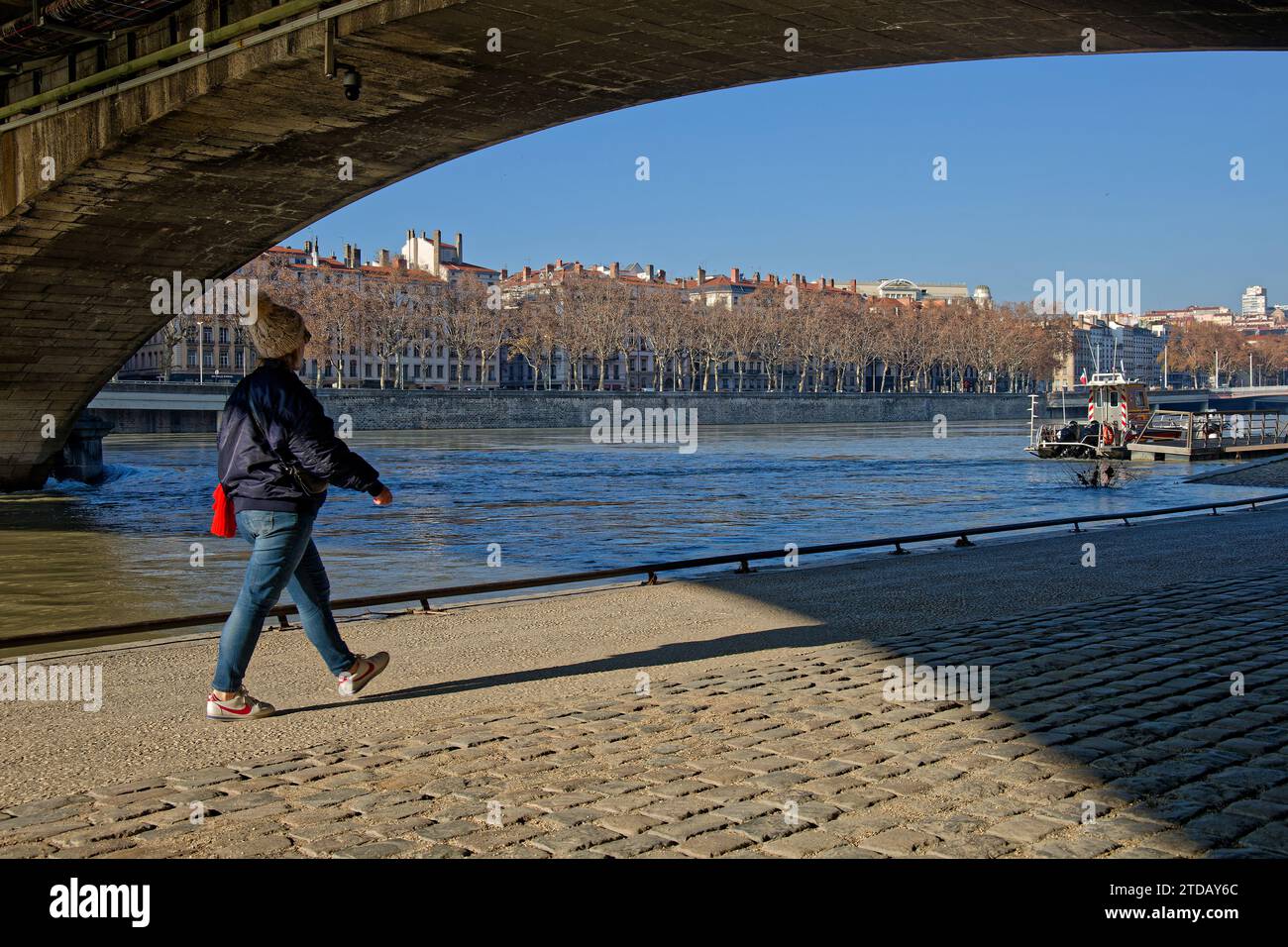 LYON, FRANCE, December 17, 2023 : Sunny sunday walk on the Rhone river ...