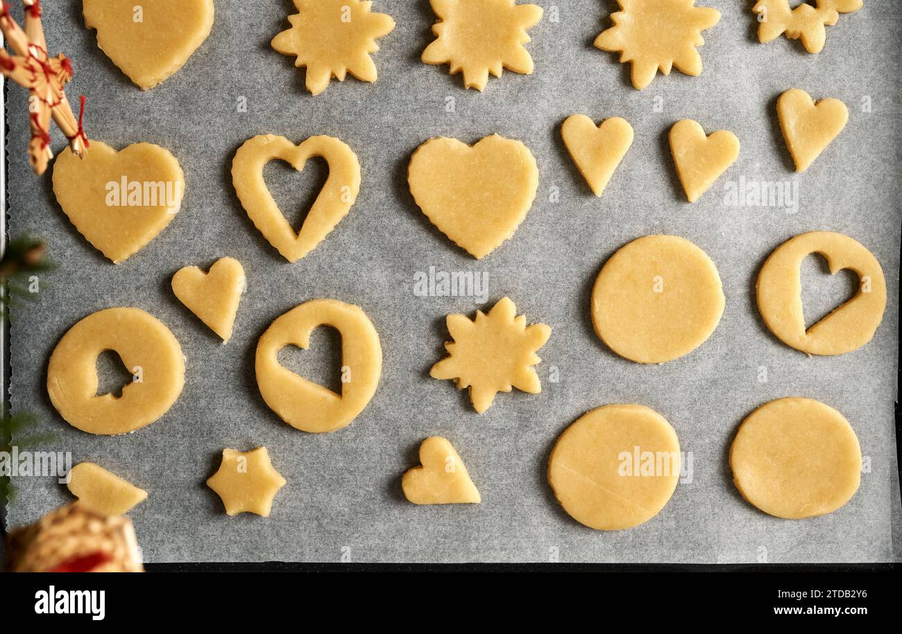 Shapes made of raw pastry dough on baking sheet - preparation of Linzer ...