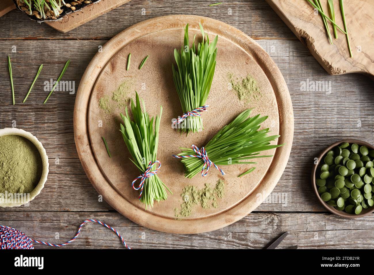 Three bundles of fresh green barley grass blades with powder and ...