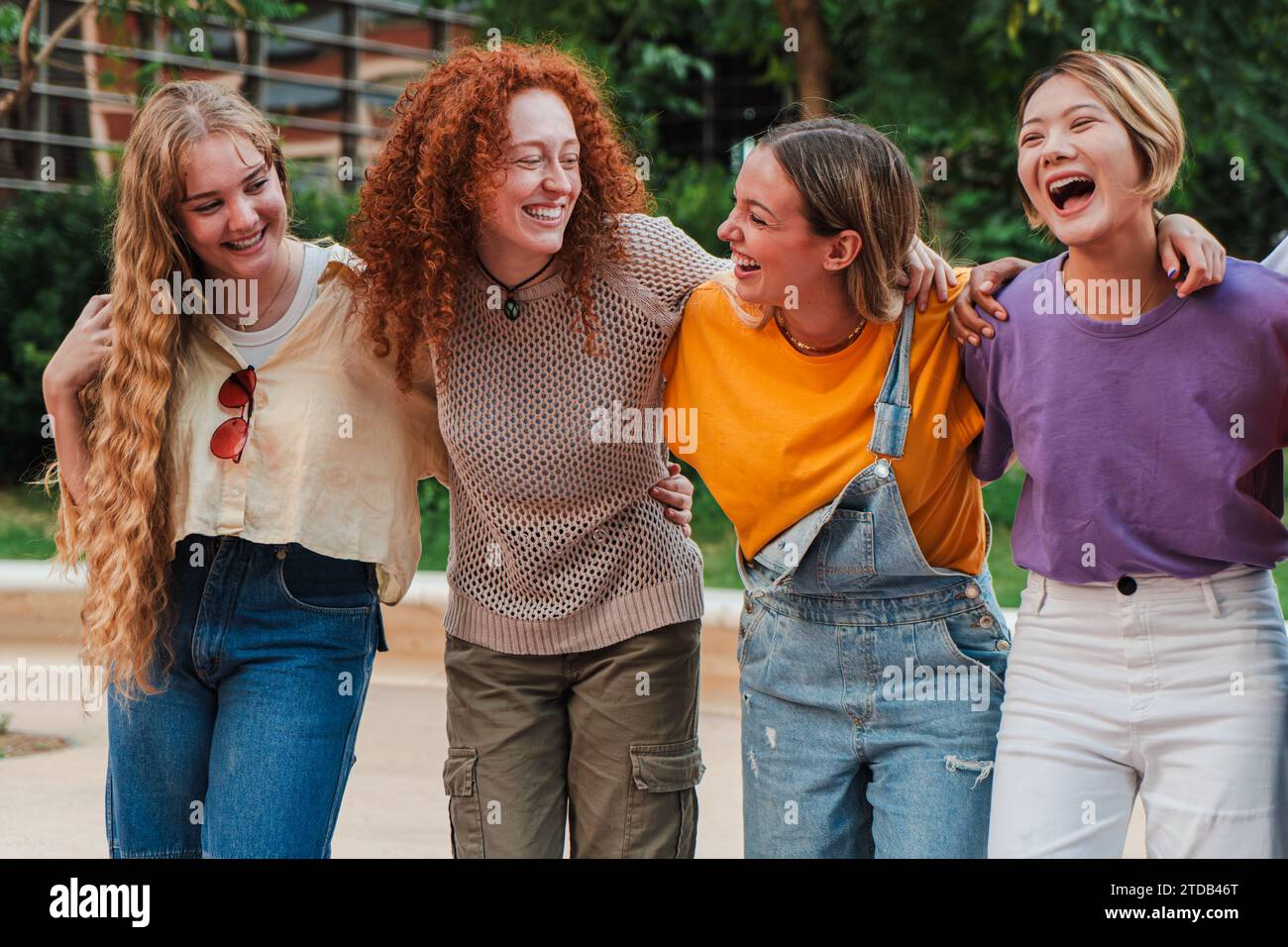 Group of joyful college student women in casual clothing, laughing and ...