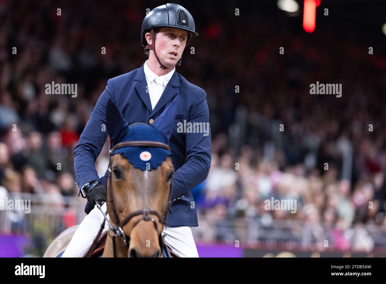 London, UK. December 17, 2023. Ben Maher of Great Britain with Enjeu de Grisien competing during ...
