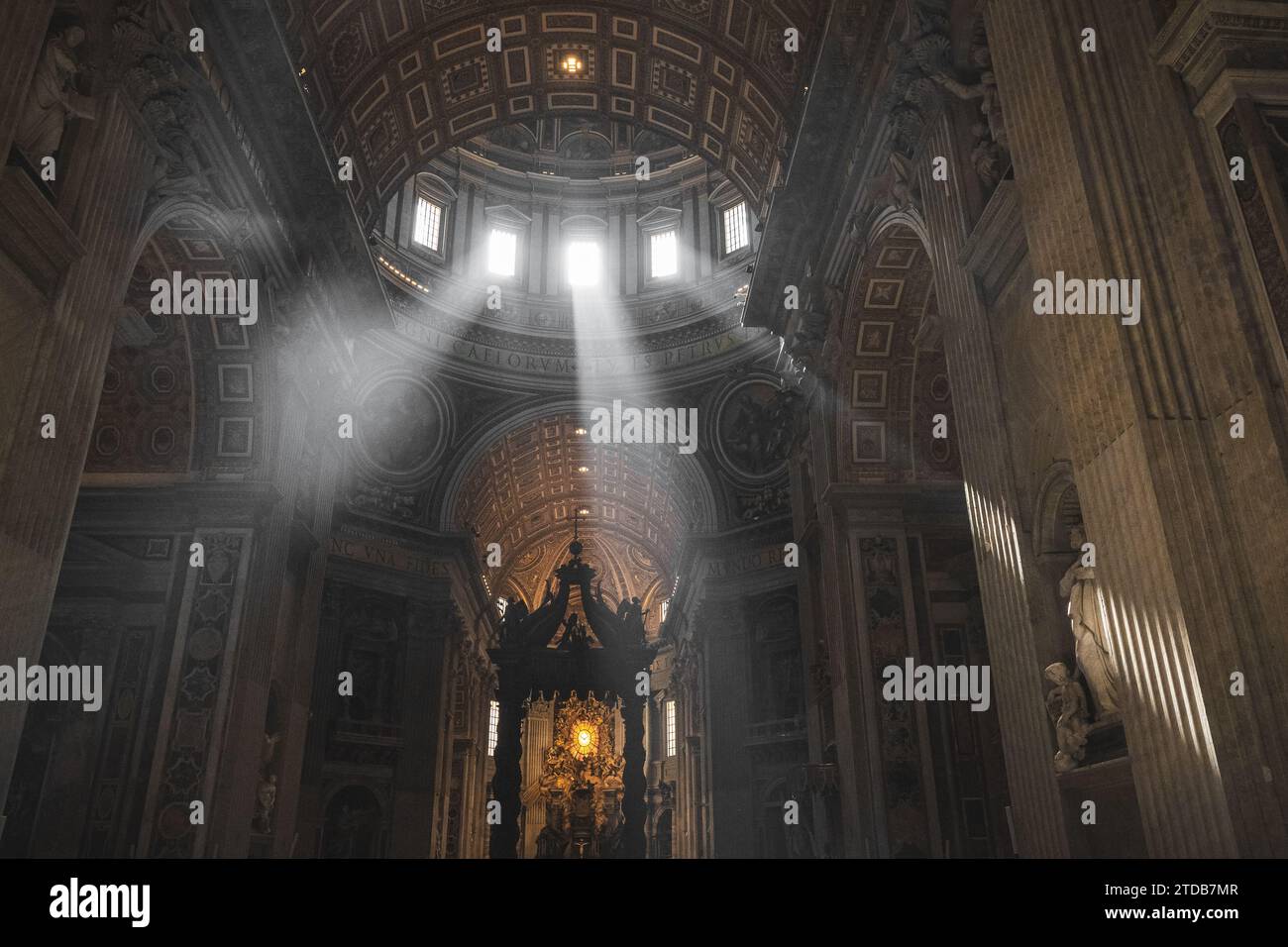 View of St. Peter’s Basilica interior with rays of light falling on ...