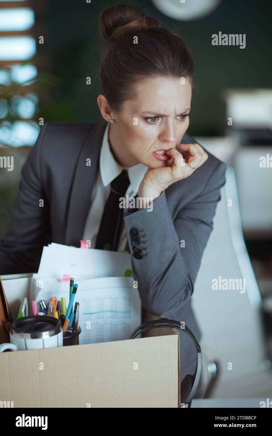 New job. concerned modern female employee in modern green office in ...
