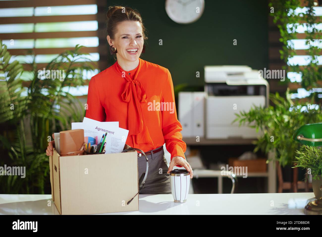 New job. smiling modern 40 years old woman worker in modern green ...