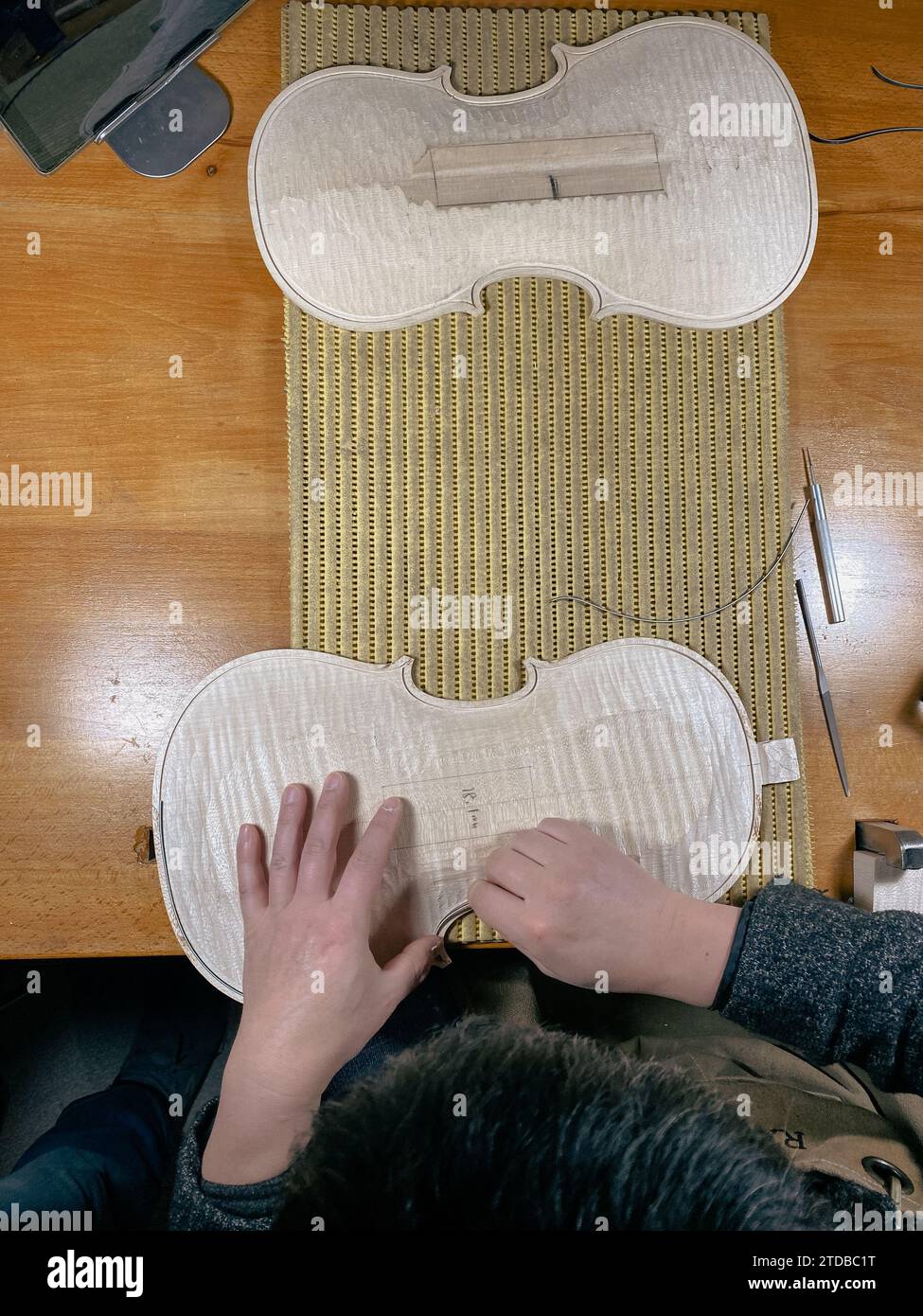 maker artisan perform purfling process on top plate of raw classical ...