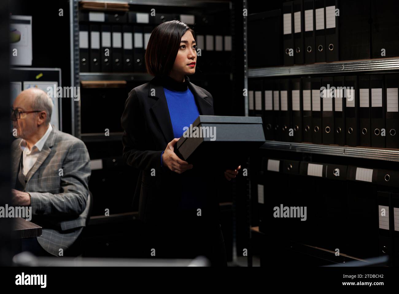 Professional asian accountant storing administrative analytical data ...