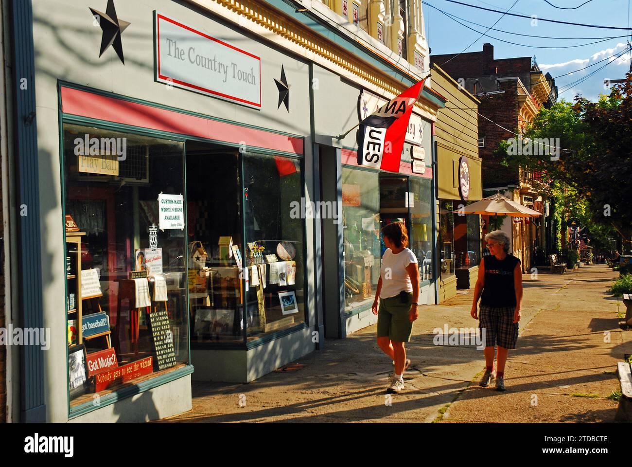 Two adult women window shop along the Main Street in Cold Spring, New ...