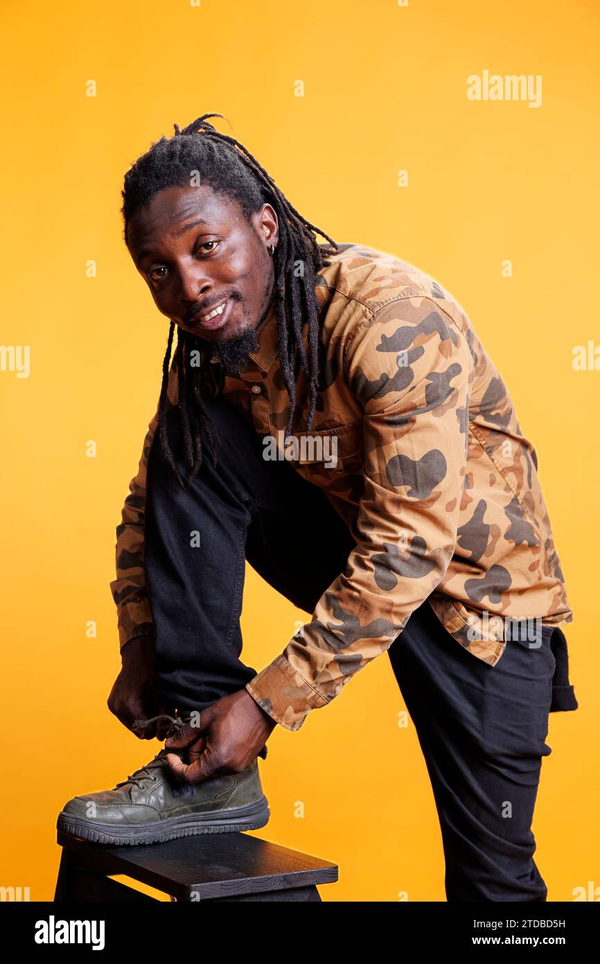African man tying sneaker hi-res stock photography and images - Alamy