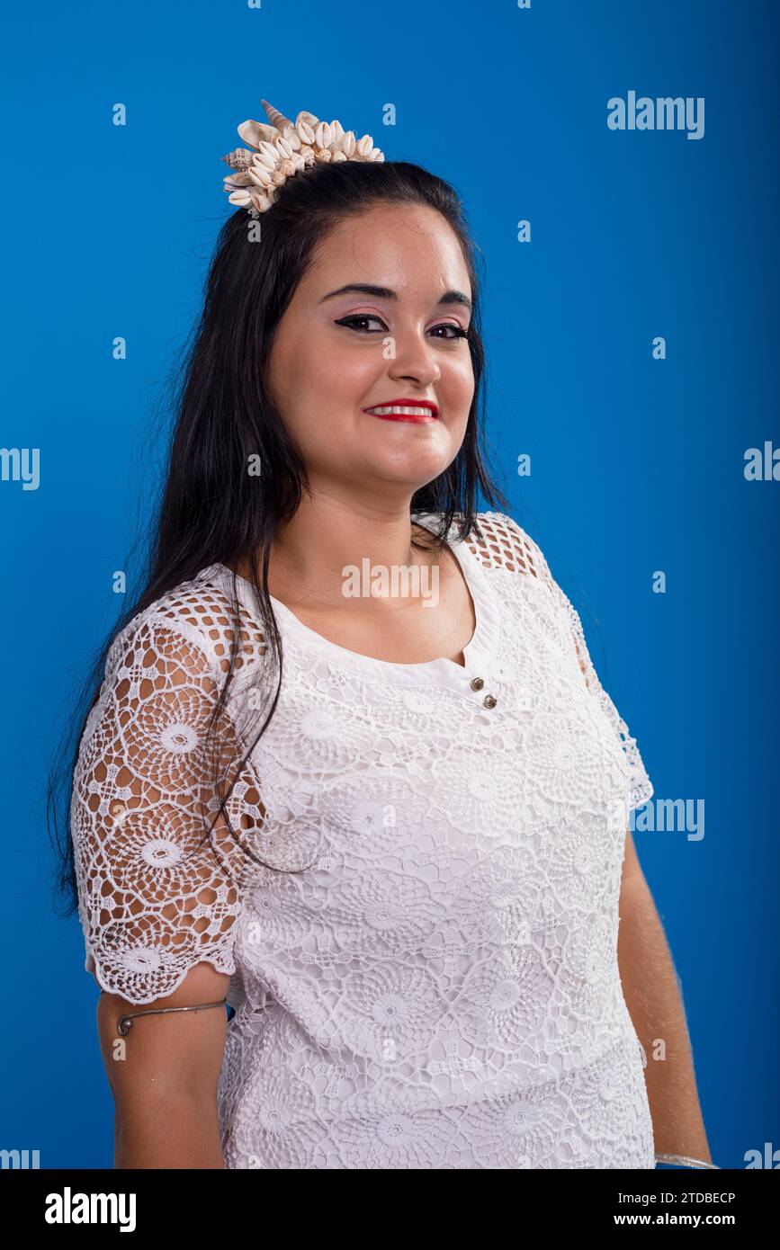 Beautiful young woman in white dress with shell tiara on her head ...
