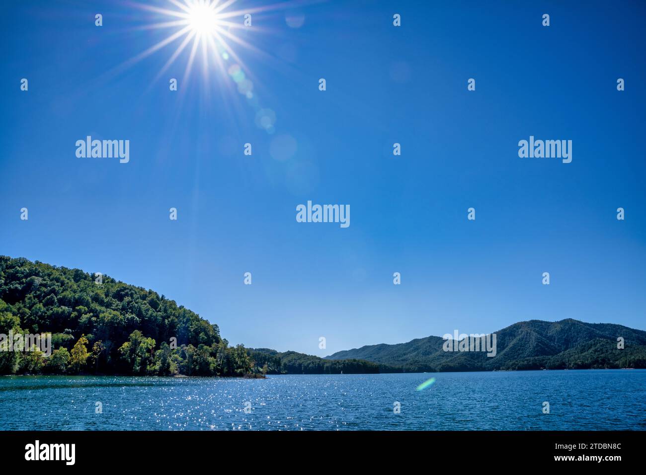 Sun forms sunstar over Lake Watuga at the Watuga Point Recreation Area ...