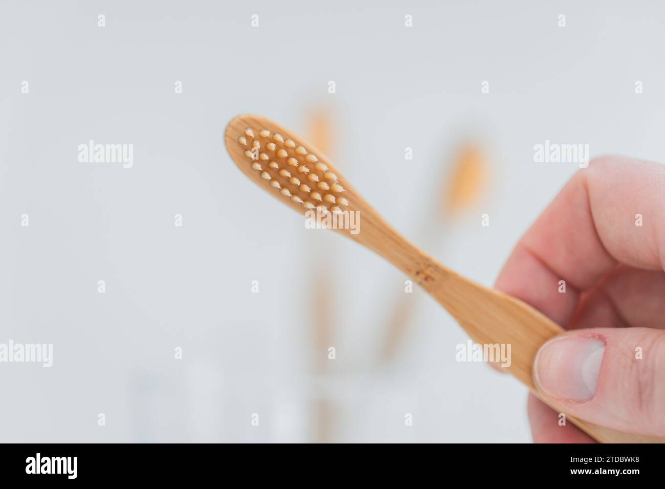 bamboo toothbrush.Teeth cleaning.Toothbrush in hand under tap water in ...