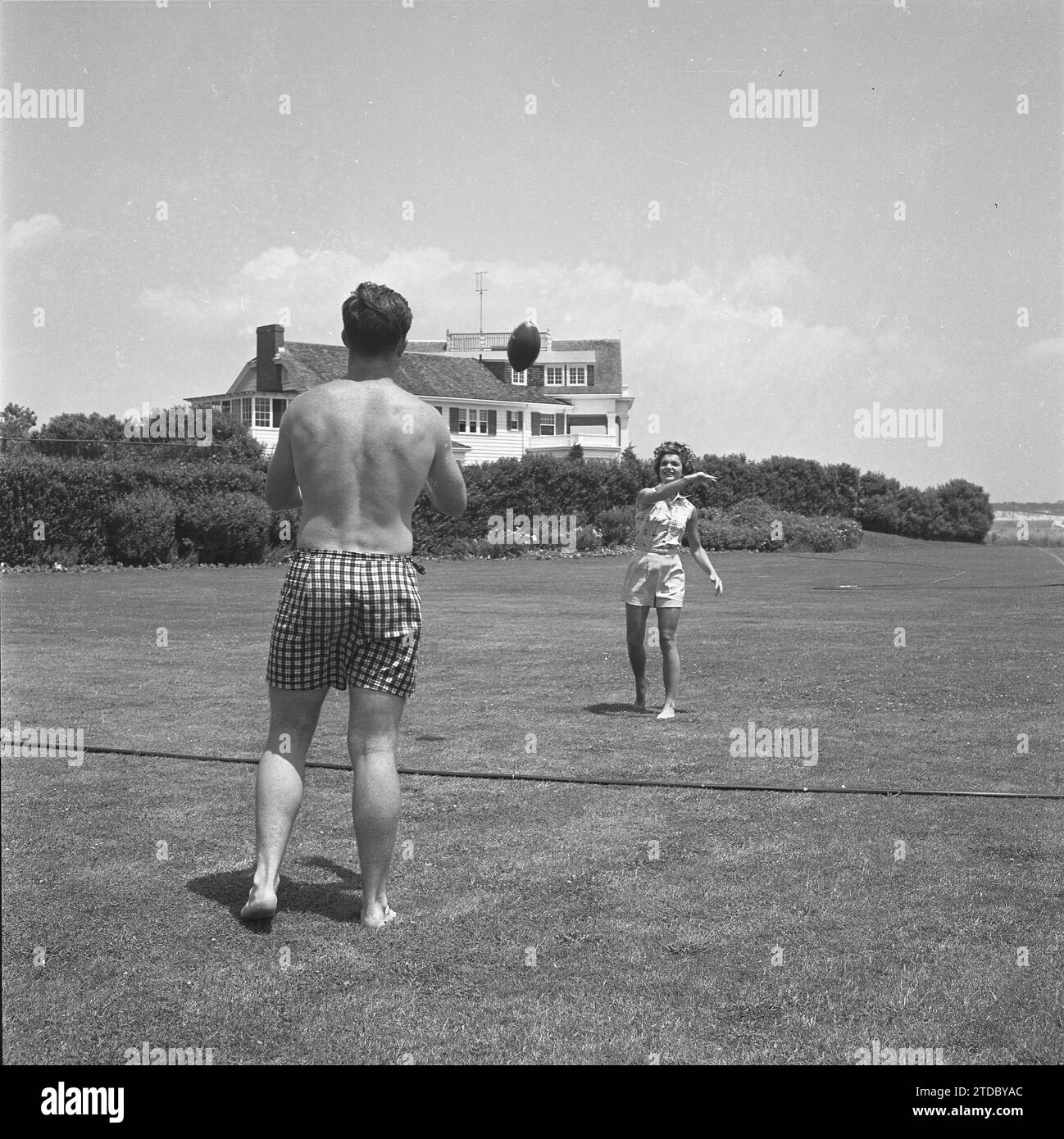 HYANNIS PORT, MA - JUNE 1953: Jacqueline Bouvier thews a footballl with ...