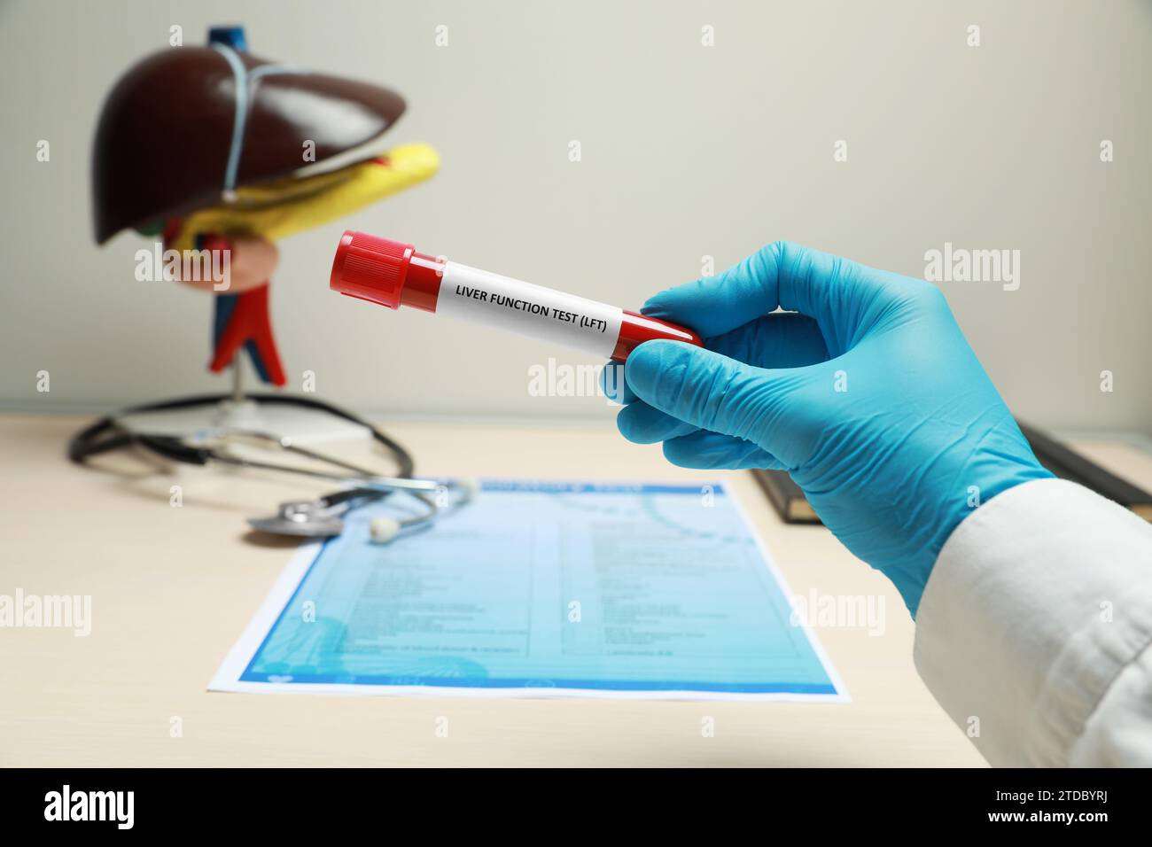 Liver Function Test. Laboratory worker with tube of blood sample, form ...