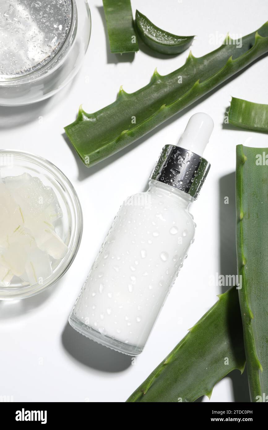 Flat lay composition with cosmetic products and cut aloe vera on white ...