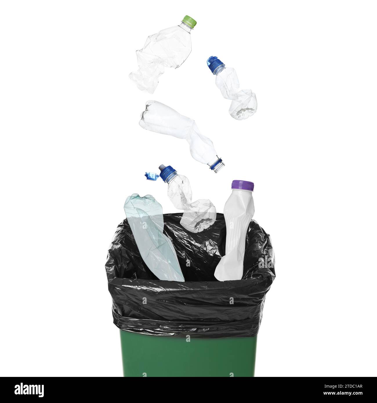 Garbage falling into trash bin on white background Stock Photo - Alamy