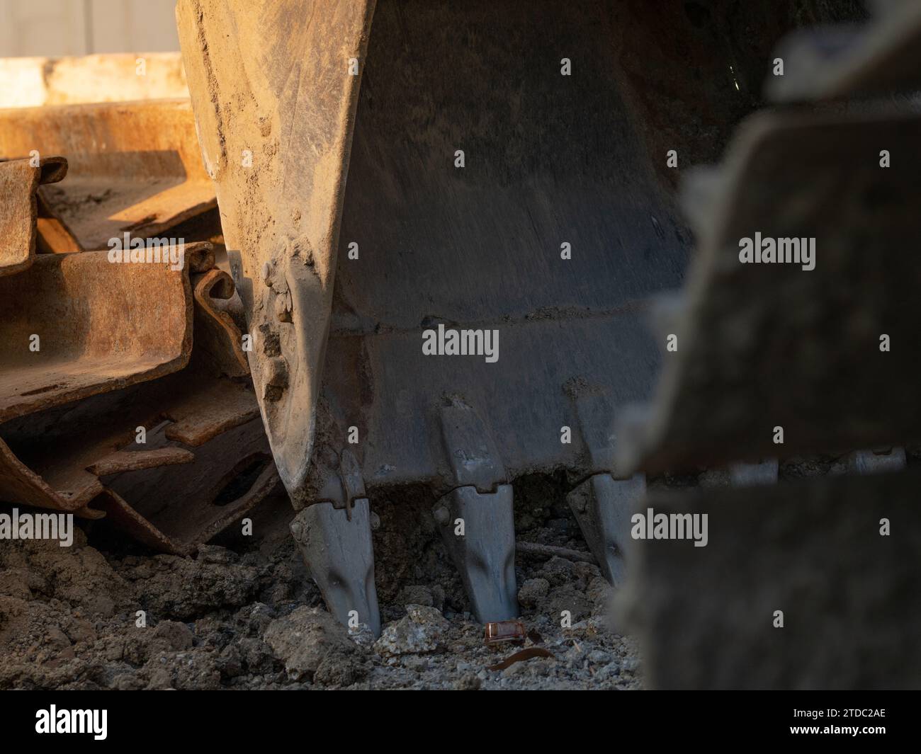 Digger parked at construction site with metal bar. Backhoe after work ...
