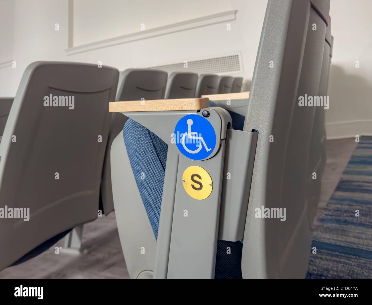 Close up image of empty ADA, accessible, gray and blue theater ...