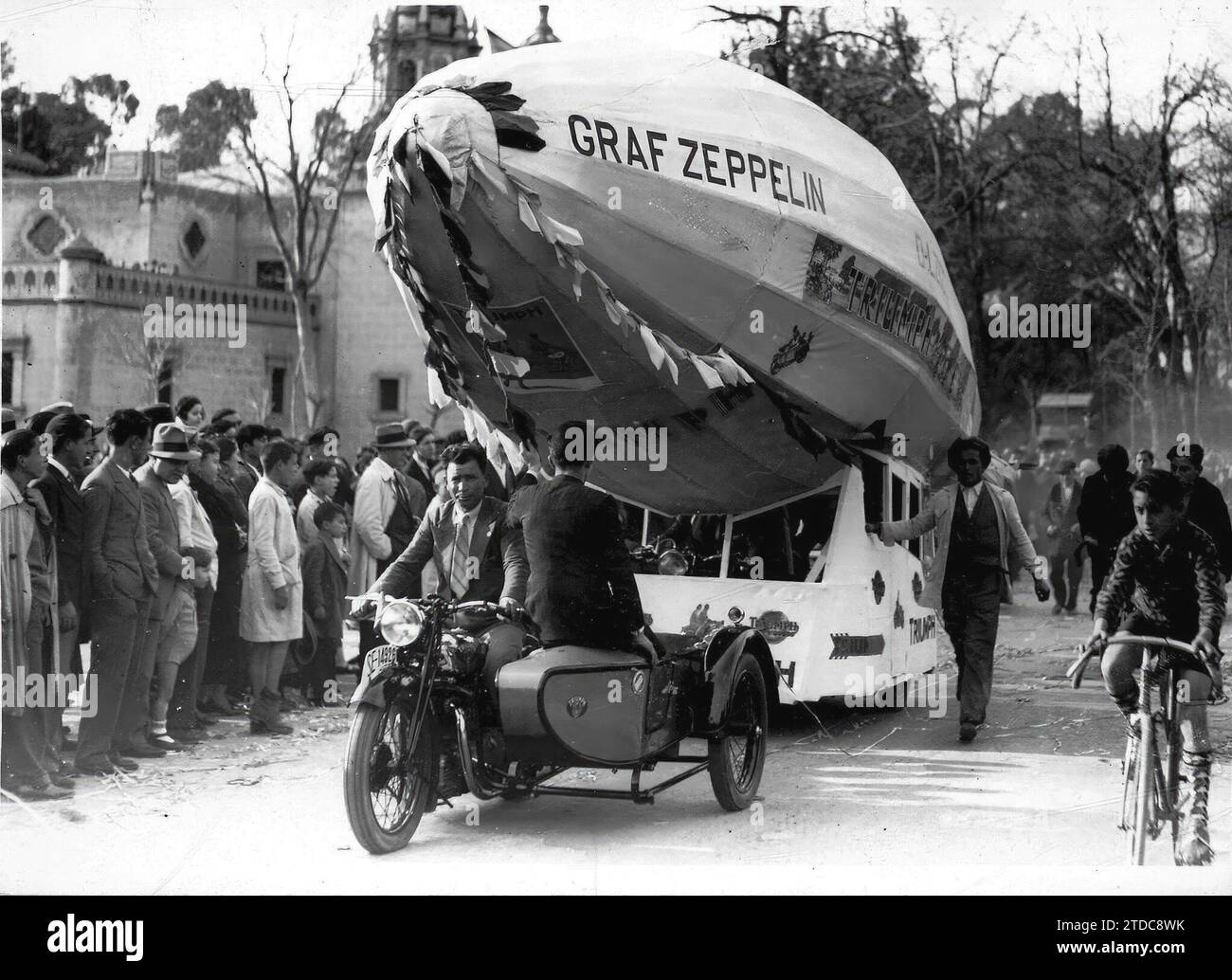 Seville. 1933. A sidecar pulling a float that reproduced Graf Zeppelin ...