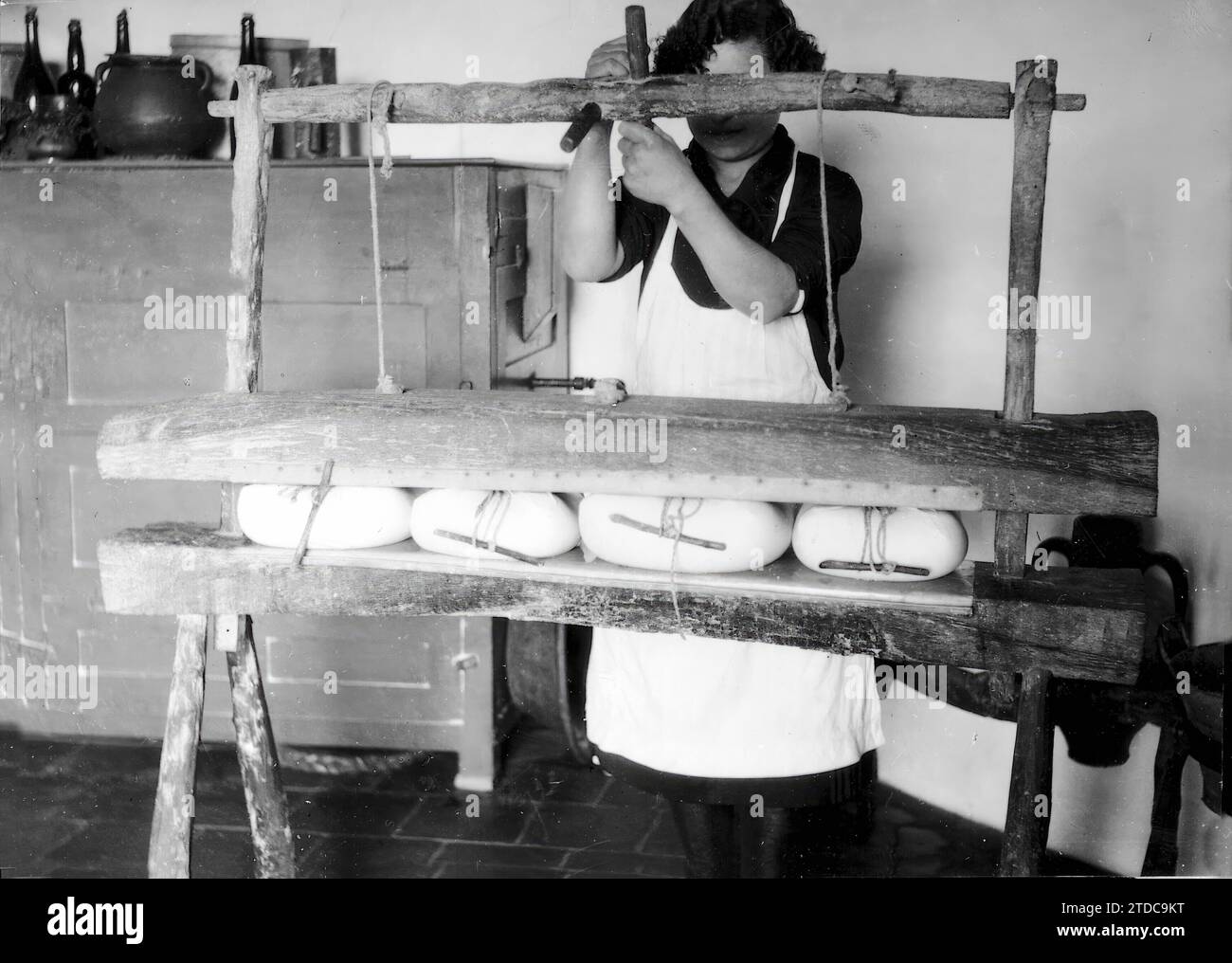 01/01/1930. Artisanal cheese preparation in a cheese factory from the ...