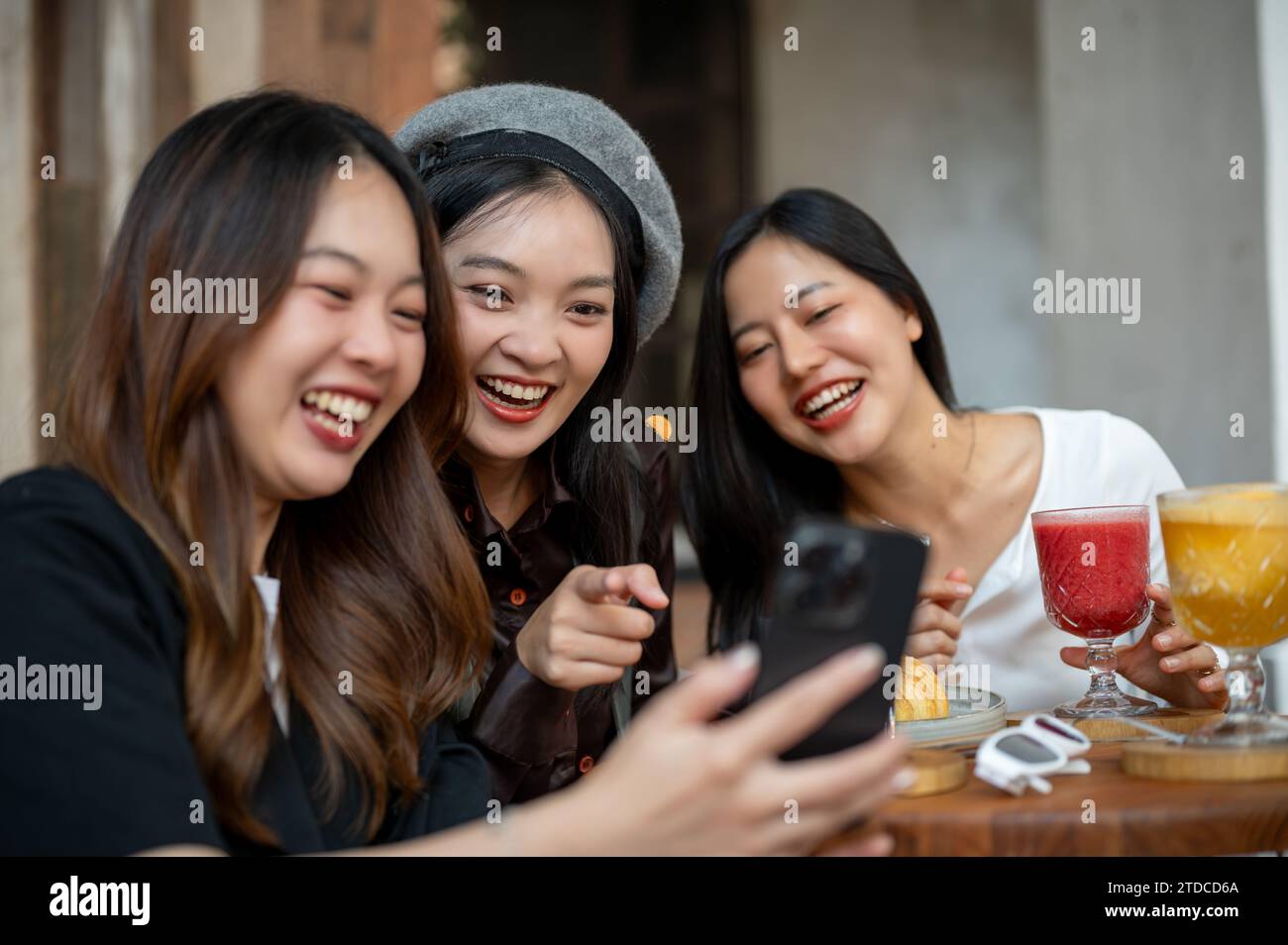 Group of positive and beautiful Asian female friends are enjoying chit ...