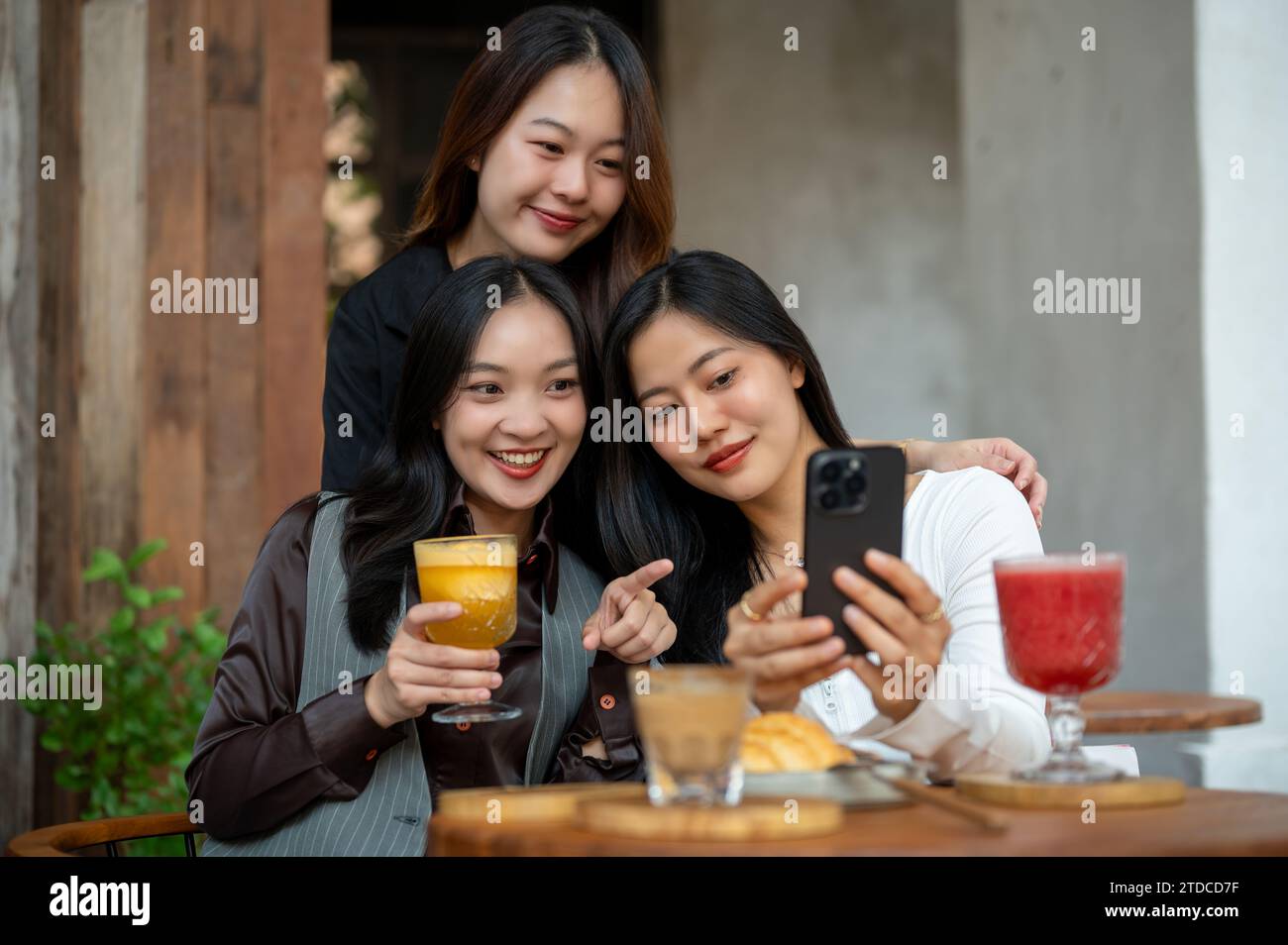 Group of positive and beautiful Asian female friends are enjoying chit ...
