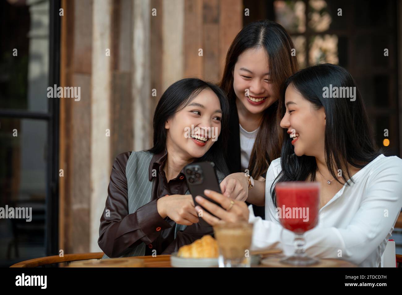 Group of positive and beautiful Asian female friends are enjoying chit ...