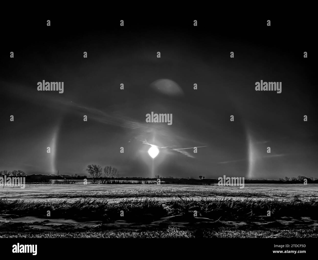 Atmospheric optical phenomenon sun dogs in the morning across a snow ...