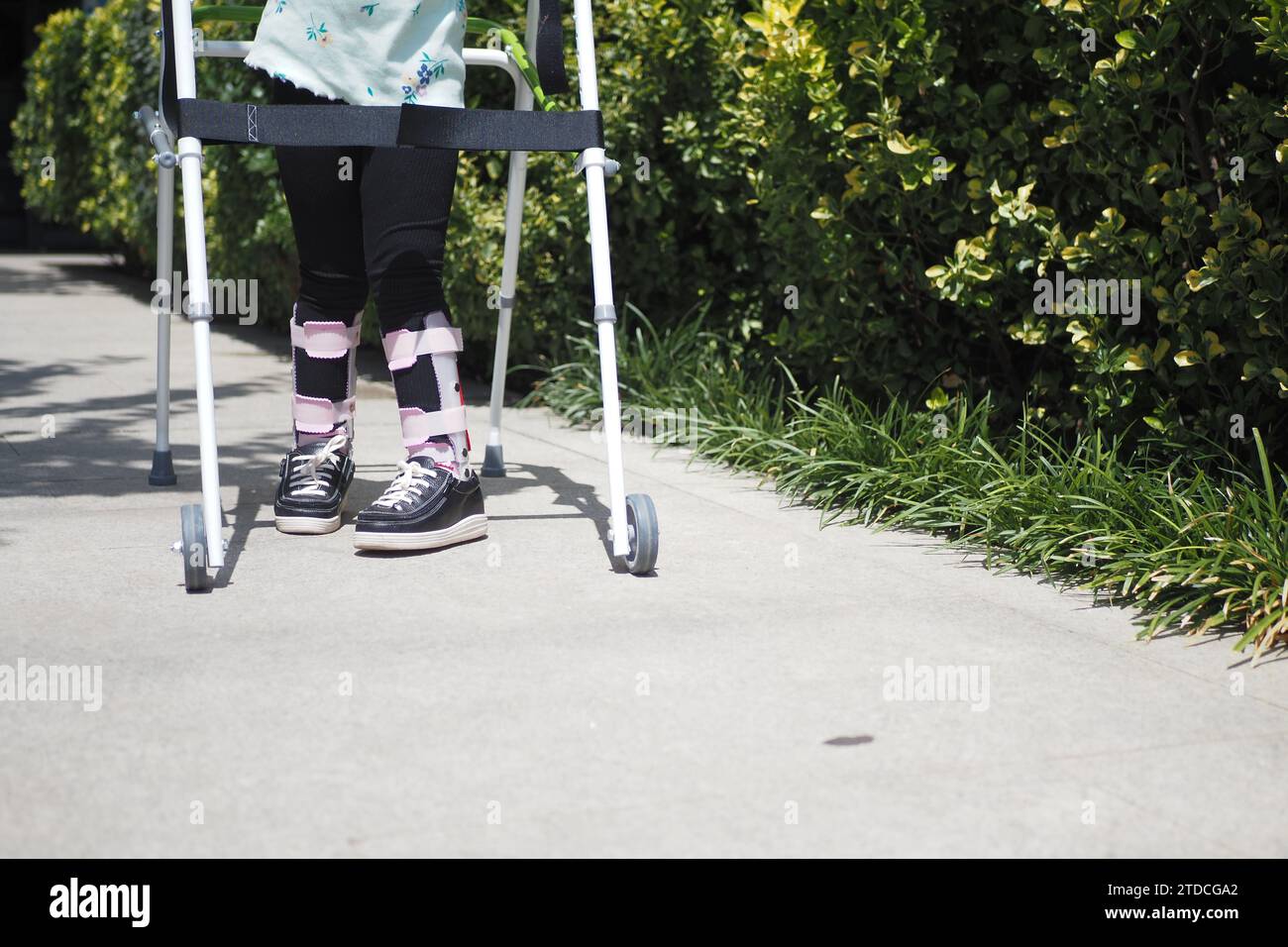 child with walking frame and knee orthosis outdoor Stock Photo - Alamy