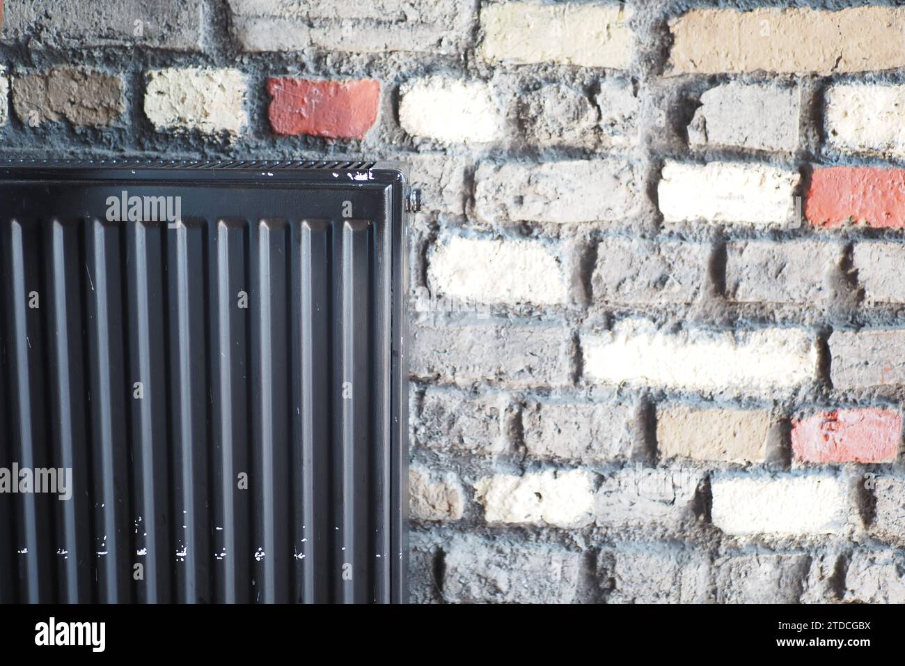 black radiator on vintage wall. apartment heating installation system ...