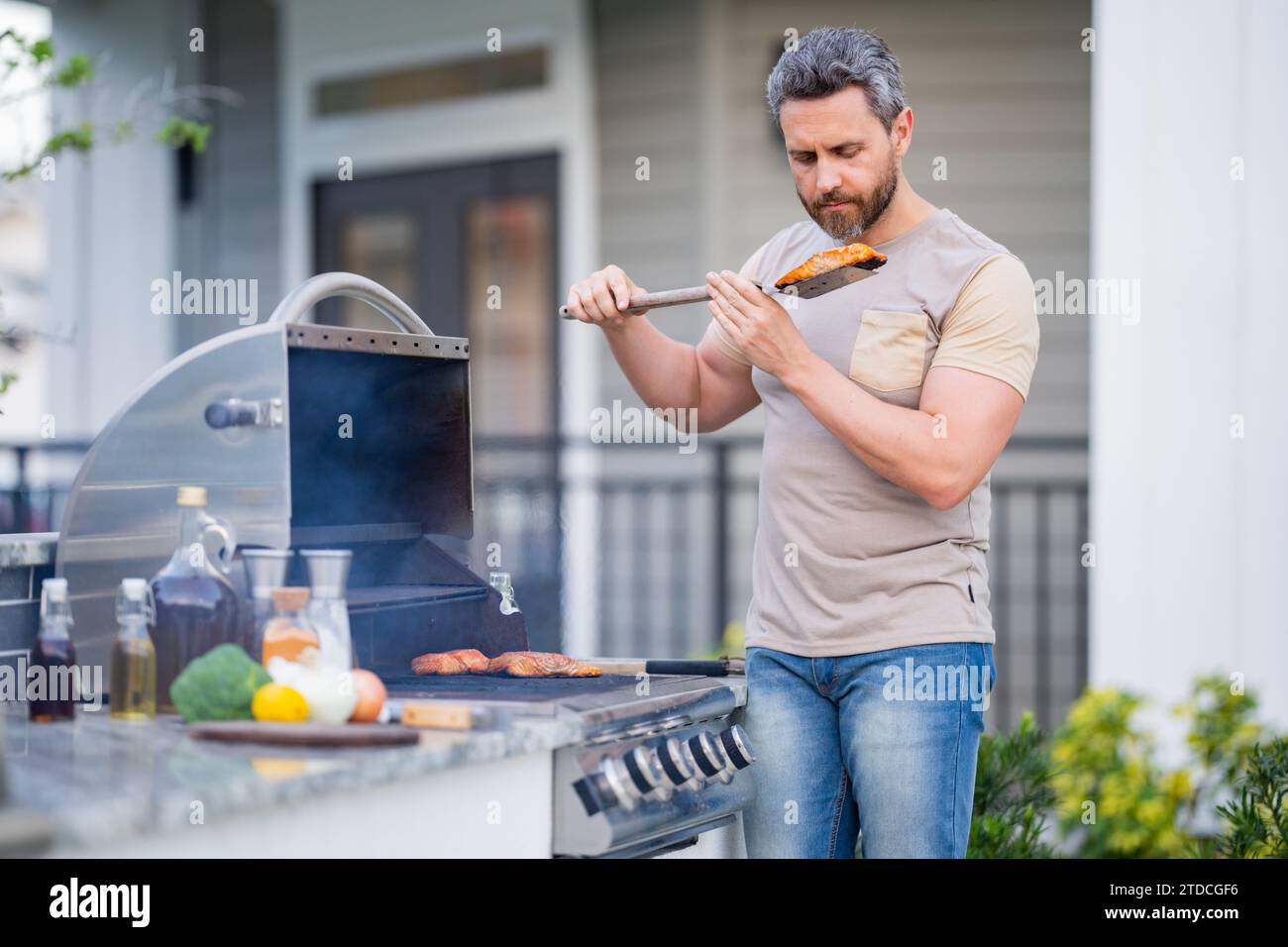 Grill and barbecue cook. Chef with BBQ cooking tools. Barbecue and ...