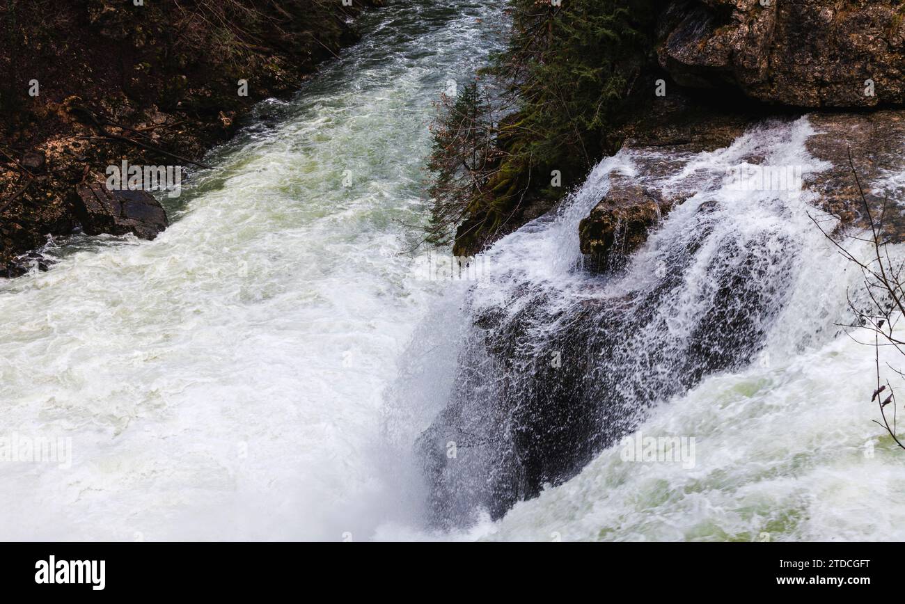 water flowing over rocks in the forest down a waterfall, close-up ...