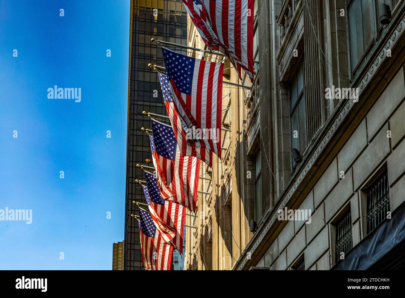 The American flags waving on the skyscrapers of Fifth Avenue, in the ...
