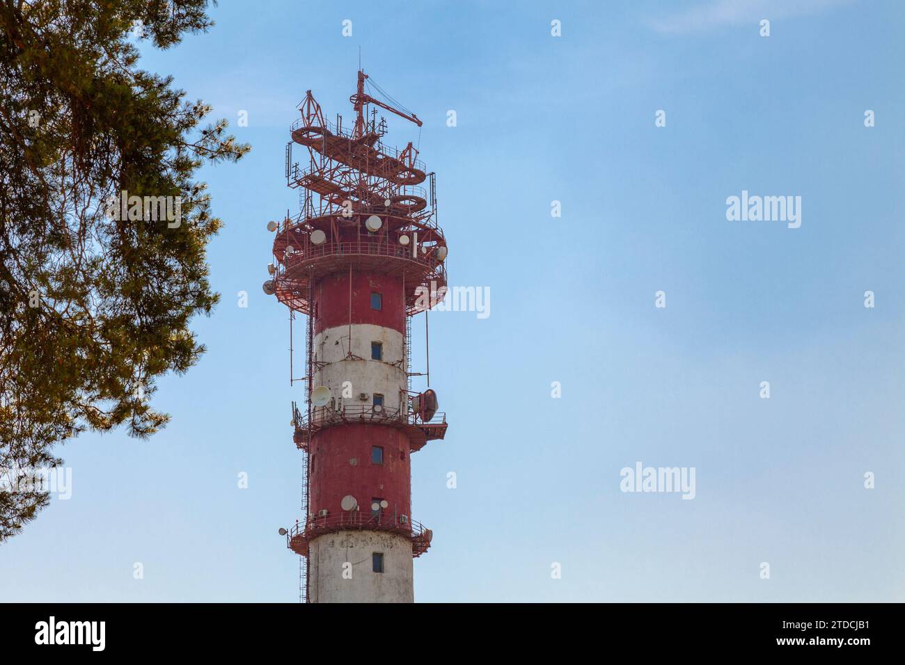 An old communications tower hung with various electronic devices Stock ...