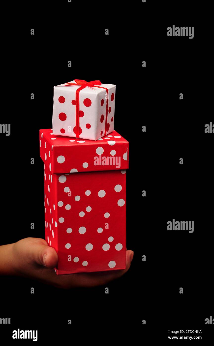 gift, closeup side view small present or gift boxes on hand palm ...