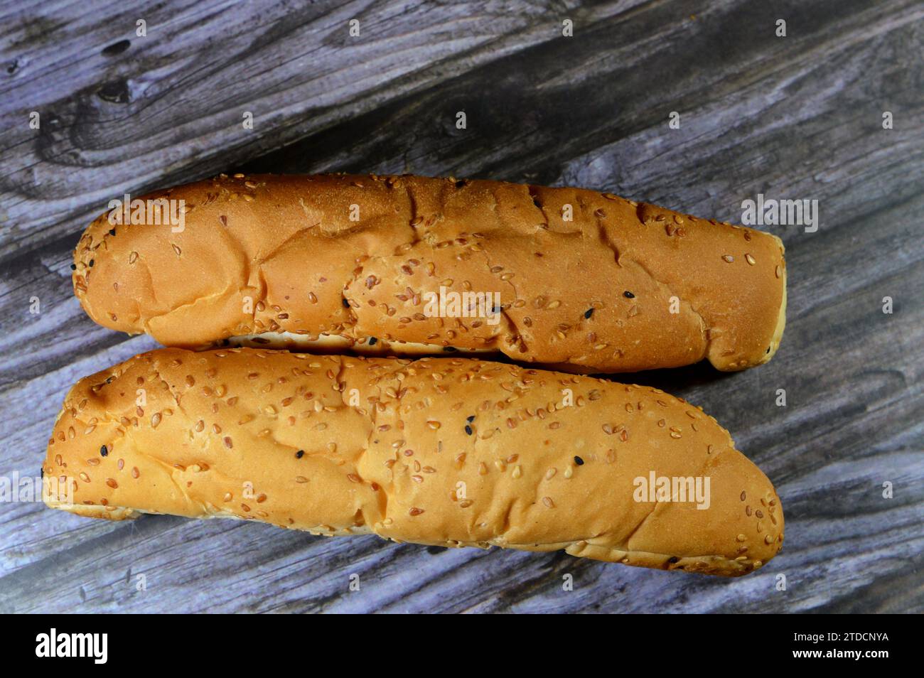 Long sesame and black Baraka seed bun bread, fresh baked loaf of bread ...
