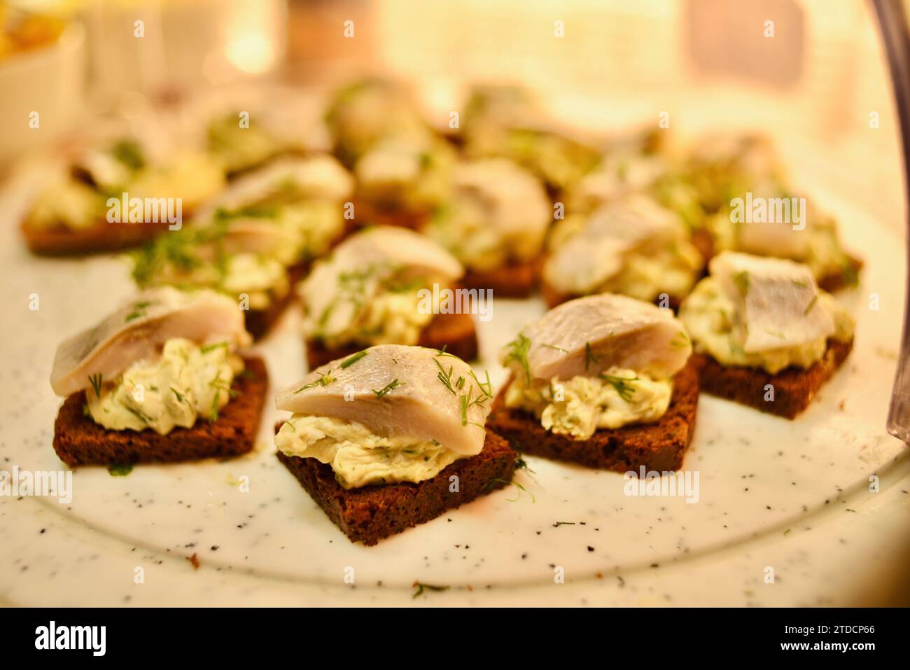 Traditional cured herring on Estonian rye bread as finger food ...