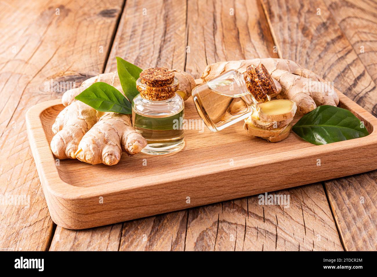 Two glass bottles with a cork cap with natural organic ginger root oil ...